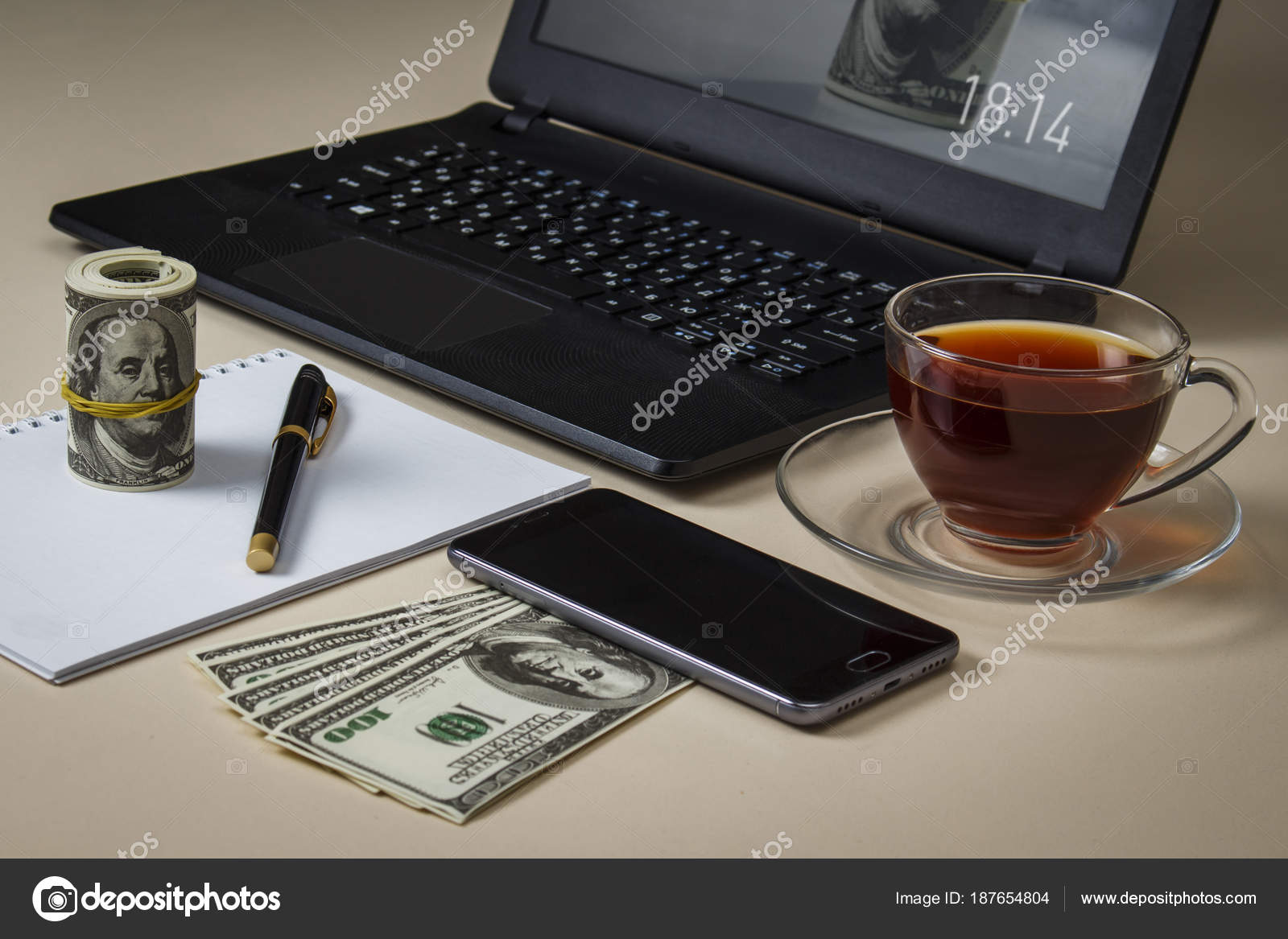 A table of a successful businessman with dollars and gadgets Stock ...