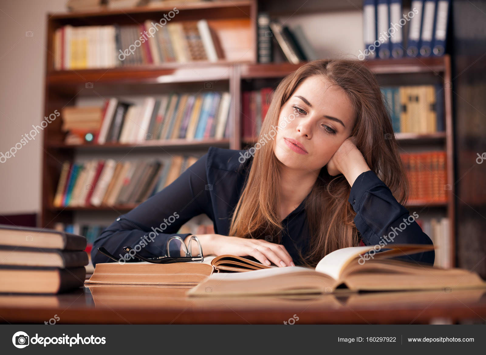 Girl student sits in the library reading — Stock Photo © dsimakov-foto ...