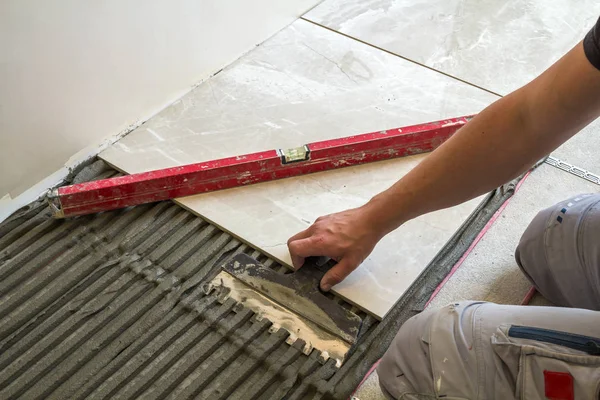 Placing a ceramic tile Stock Photos, Royalty Free Placing a ceramic ...