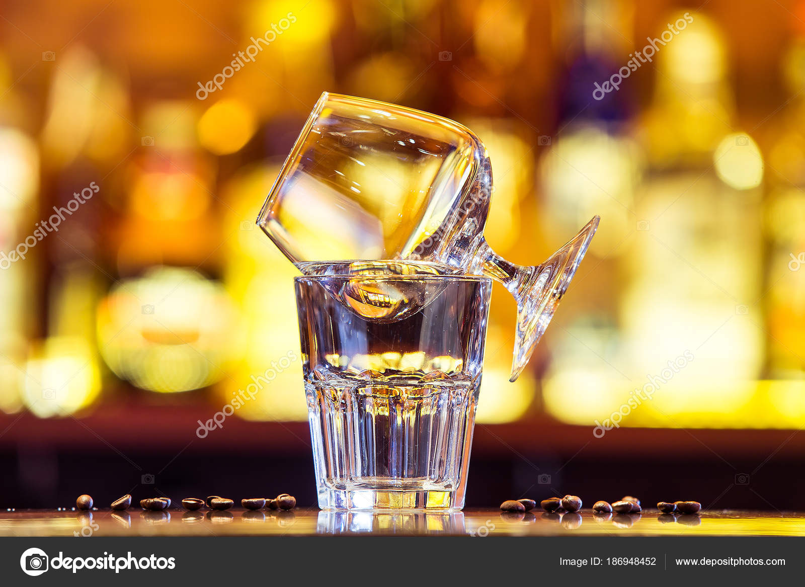 Sambuca cocktail on the bar (close). Behind the bright yellow ba ...