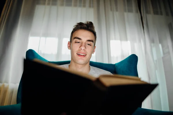 Man enjoying reading an interesting book,home alone in quarantine ...