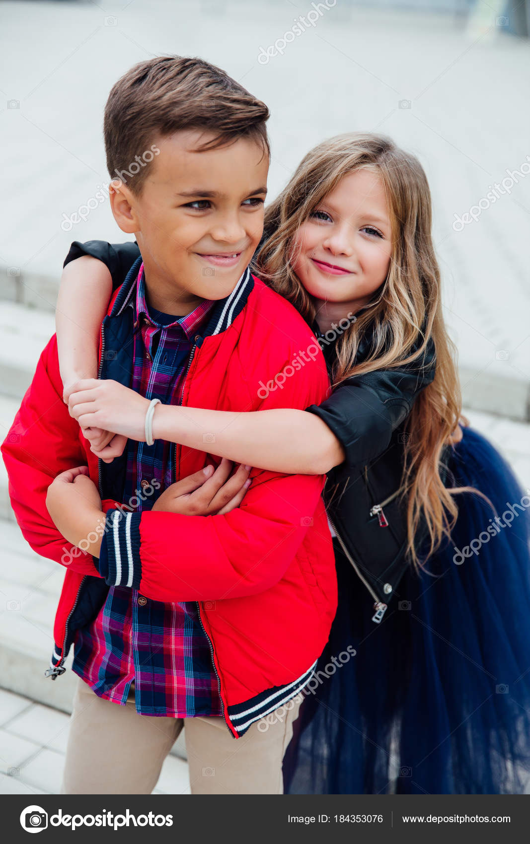Girlfriend hugs a guy from behind in the street in the city. Two ...