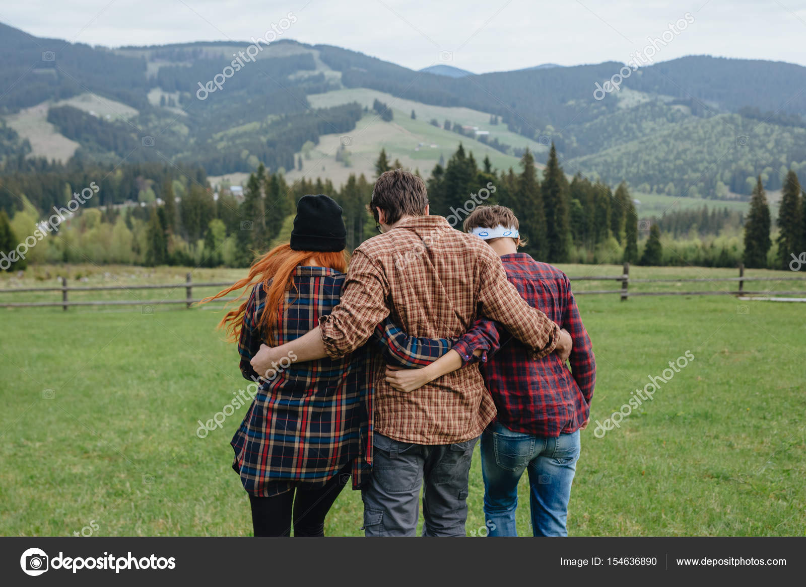 Three friends hugging and walking away. Boy and two girls traveling in ...