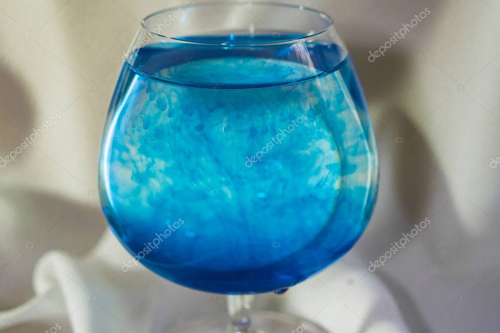 Acuarela azul en un vaso. Mezcla de colores en el vaso. Pintura al óleo ...