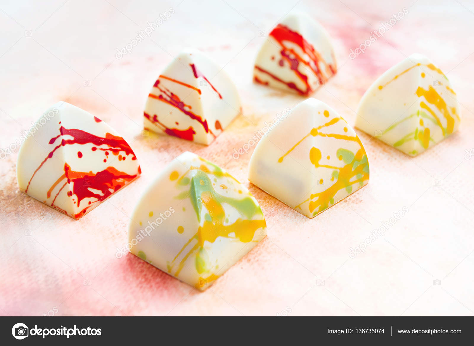 Unique handmade white chocolate sweets on abstract painting background ...