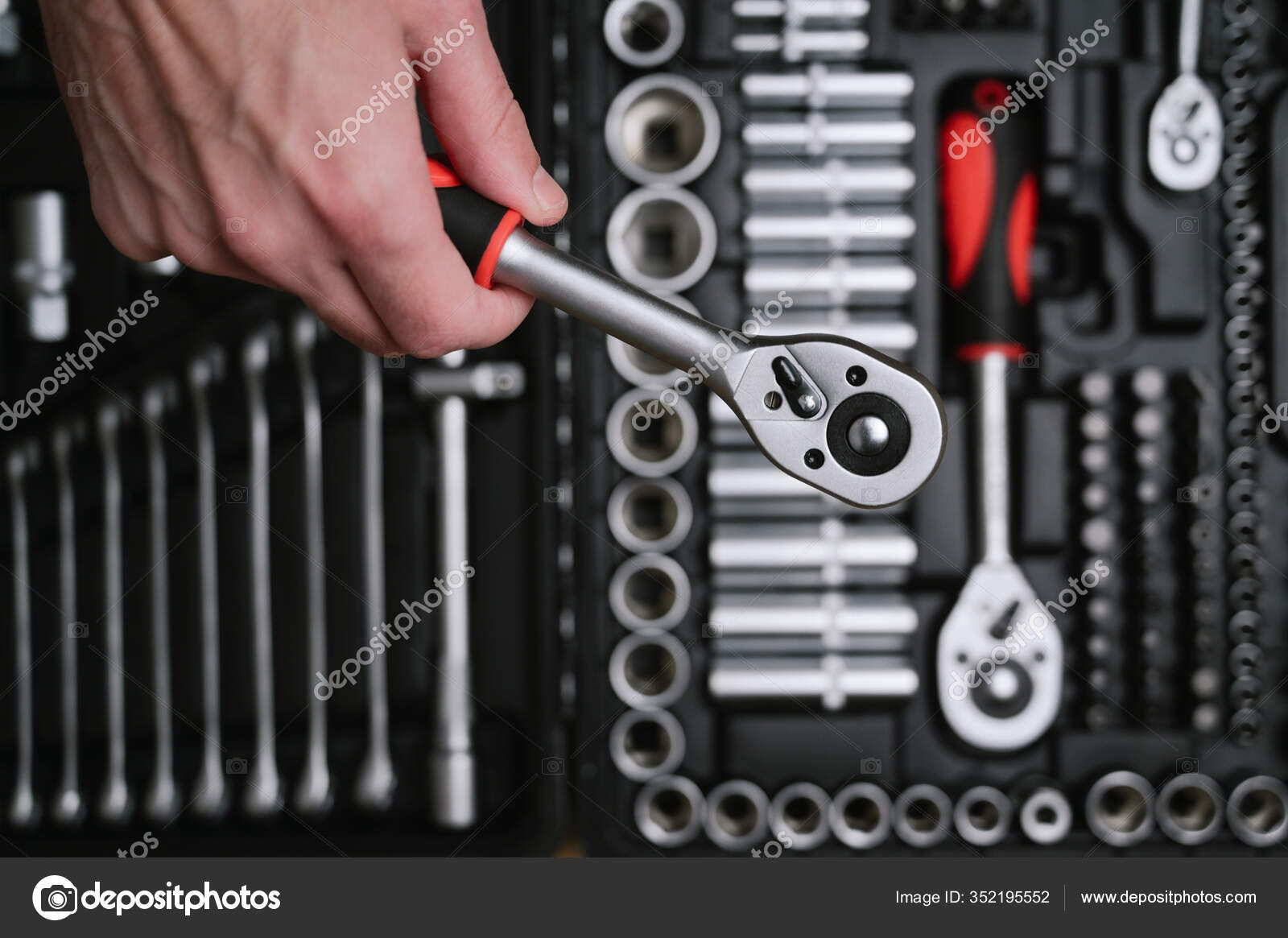 Human auto mechanic hand holding car repair tool socket wrench on tool ...