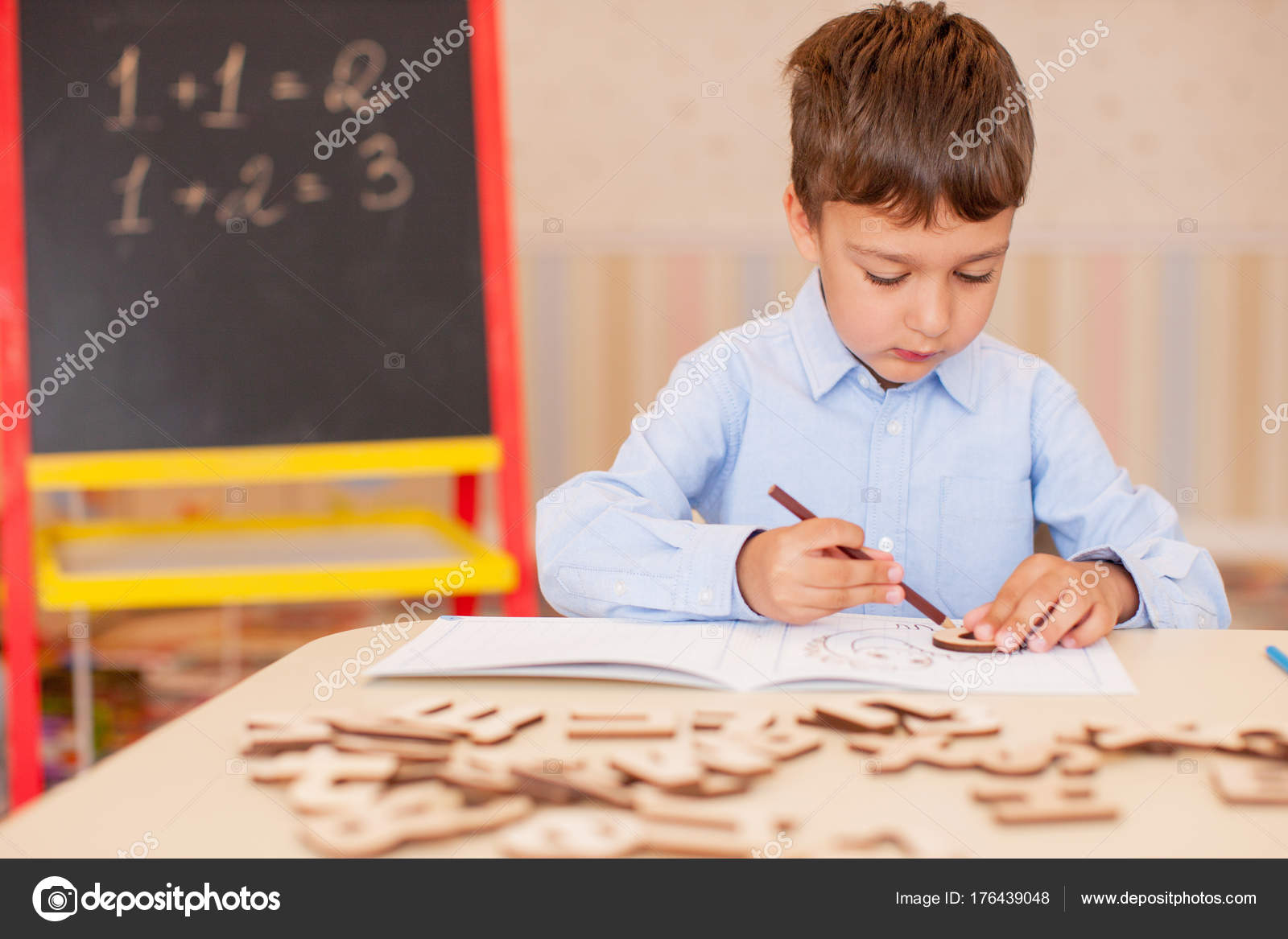 Cute Little Boy Wearing Blue Shirt Sitting Table Studying Wooden Stock ...