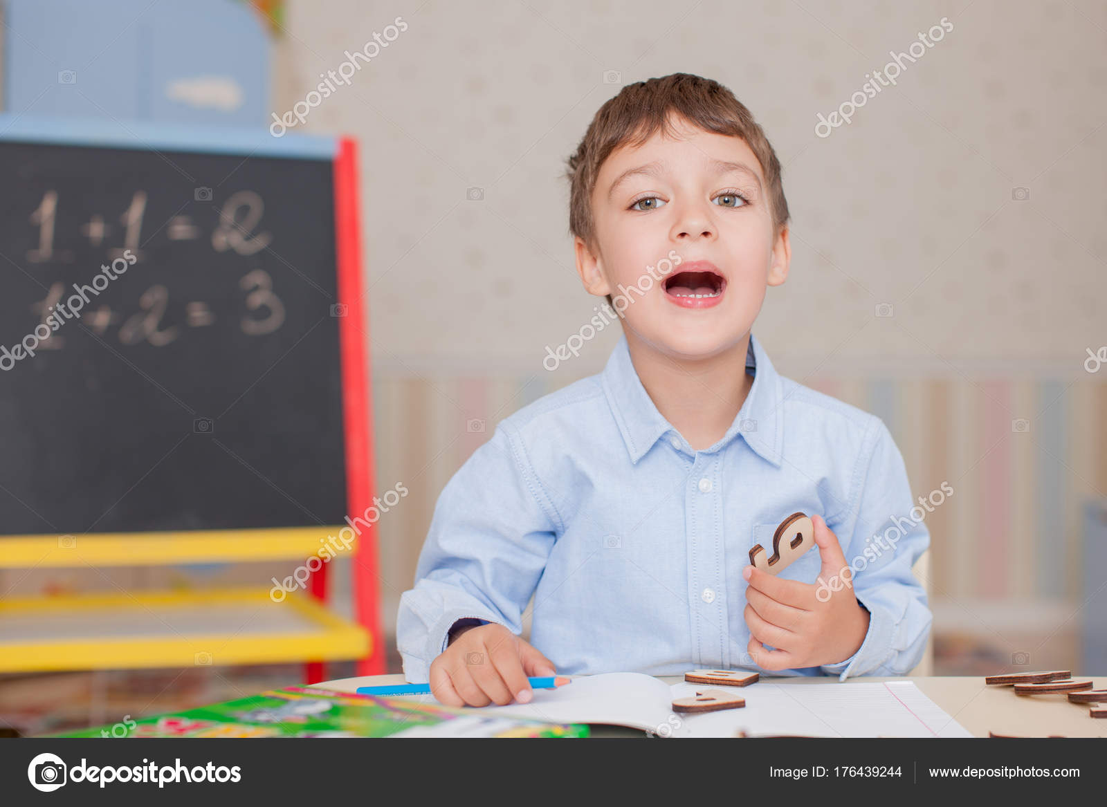 Cute Little Boy Wearing Blue Shirt Sitting Table Studying Wooden Stock ...