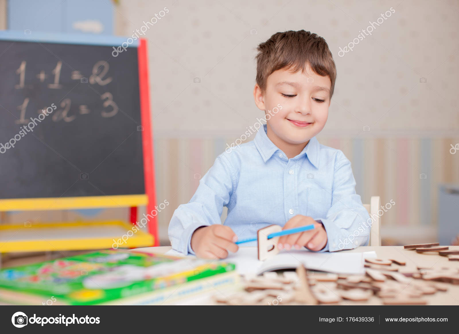 Cute Little Boy Wearing Blue Shirt Sitting Table Studying Wooden Stock ...