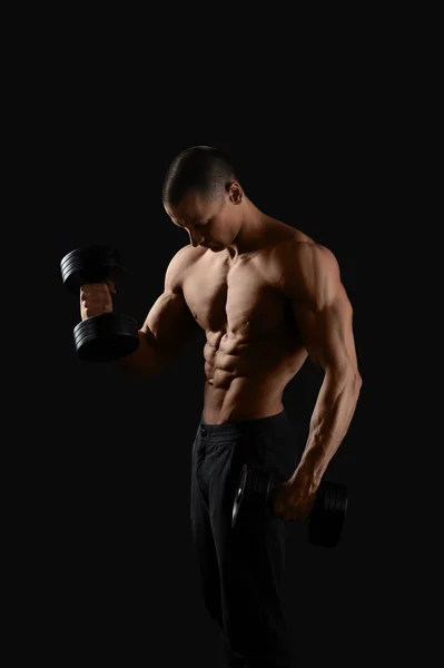 Male bodybuilder posing in studio - Stock Image - Everypixel