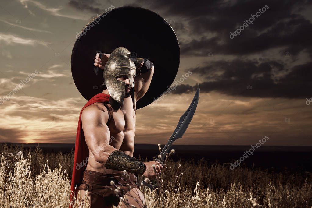Spartan warrior going forward in attack with sword. — Stock Photo ...