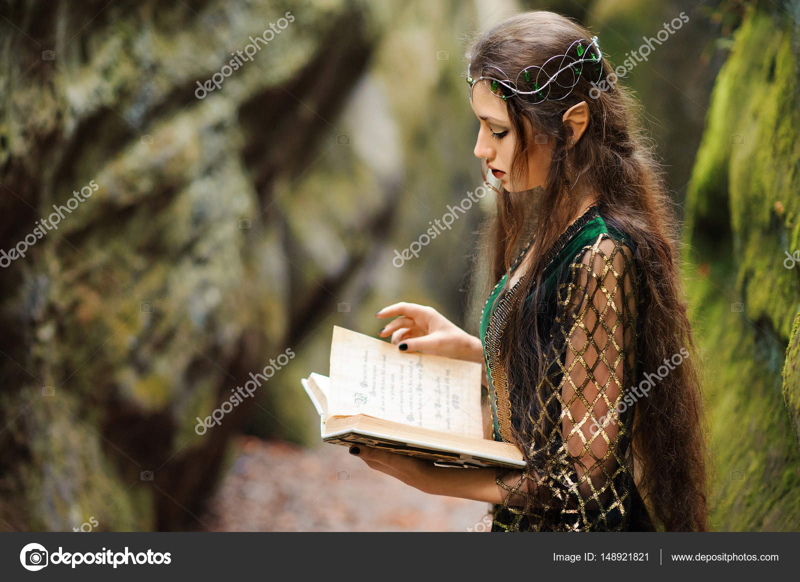 Young female elf wandering in the forest holding an old book — Stock ...