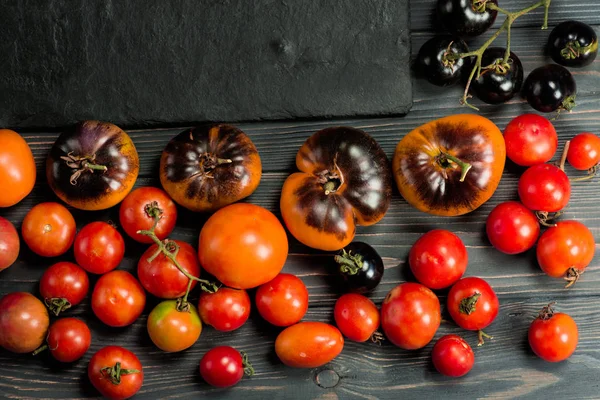 Different kind tomatoes closeup assorted. Red and yellow tomatoes ...