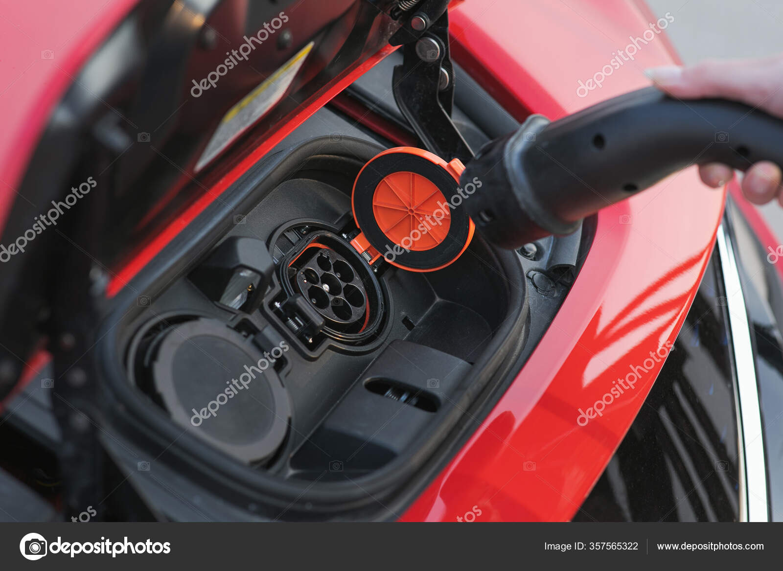Plugs in Charger into Socket of Her Modern New Red Electric Car. Woman ...