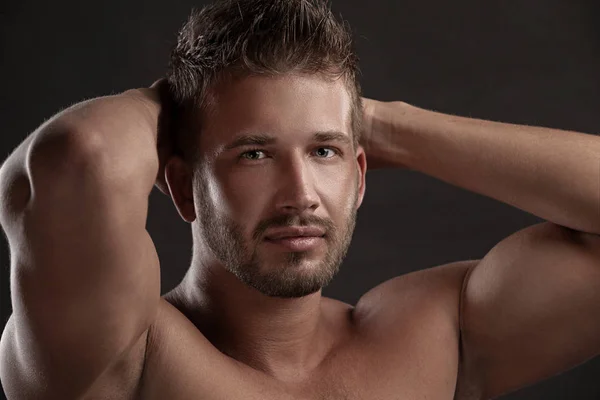Model man with an open chested on a dark background , muscular body of ...