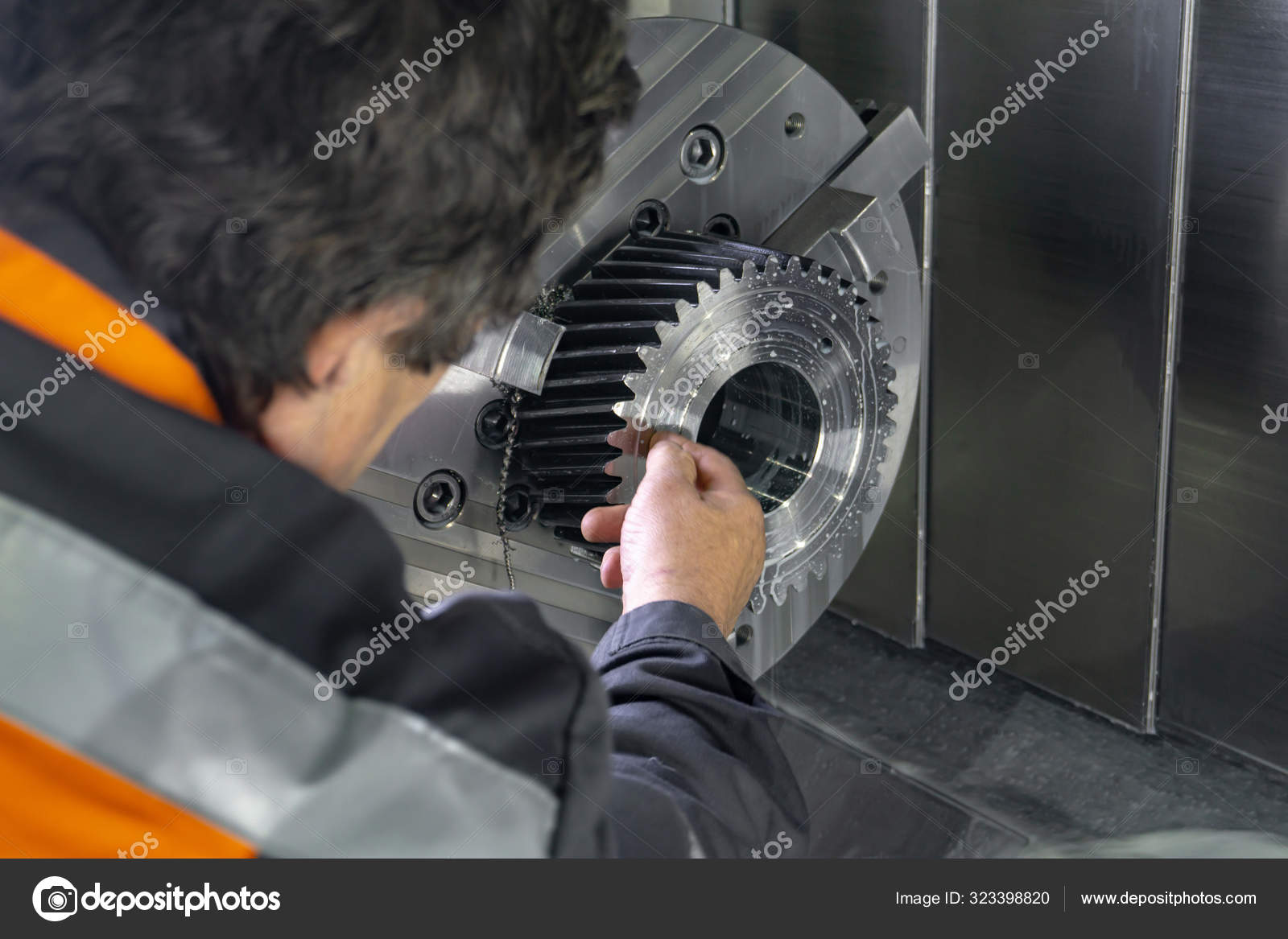 The worker measures the part installed on the machine with a cnc ...