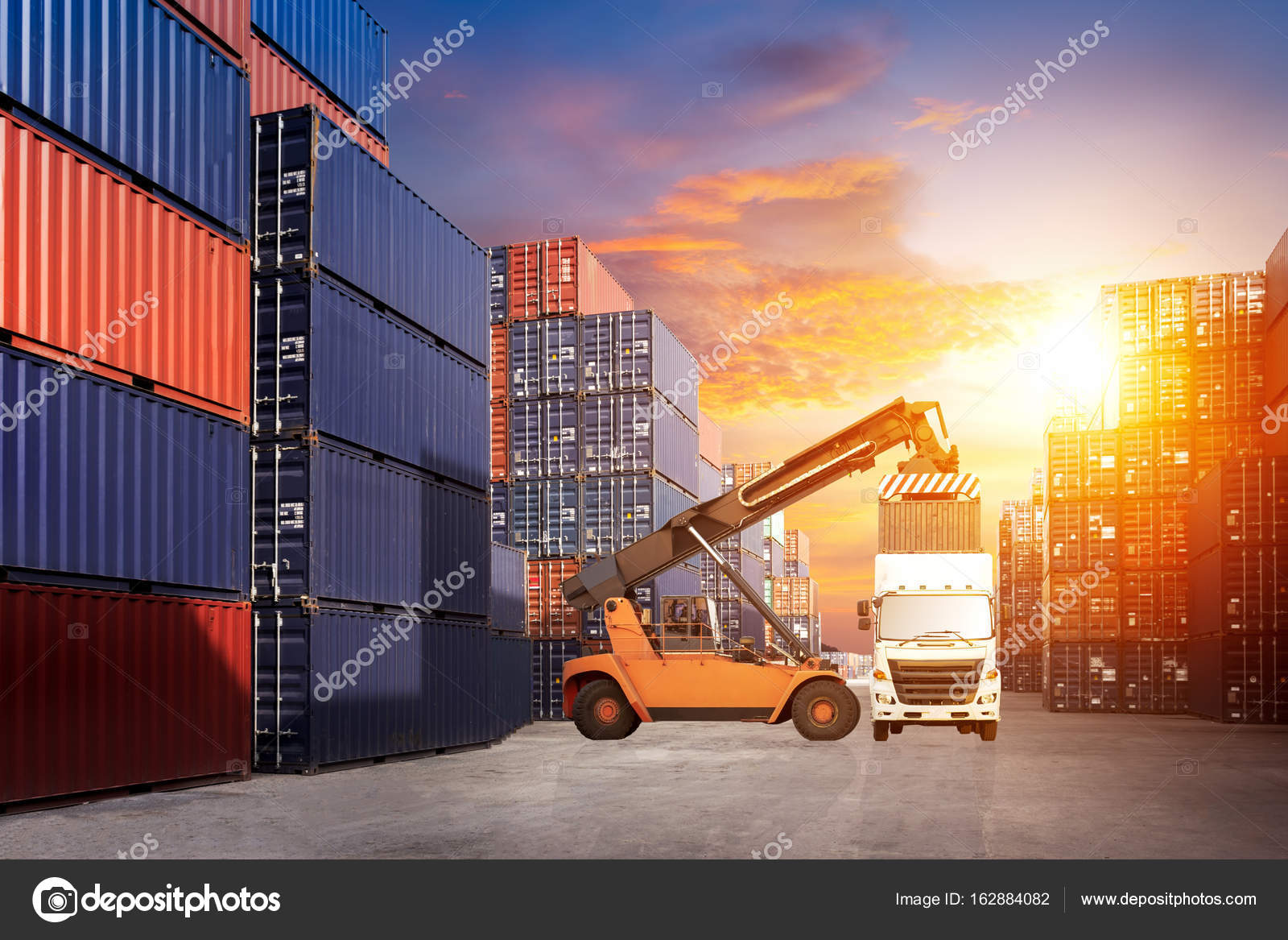 Forklift handling container box loading to freight train in import and ...