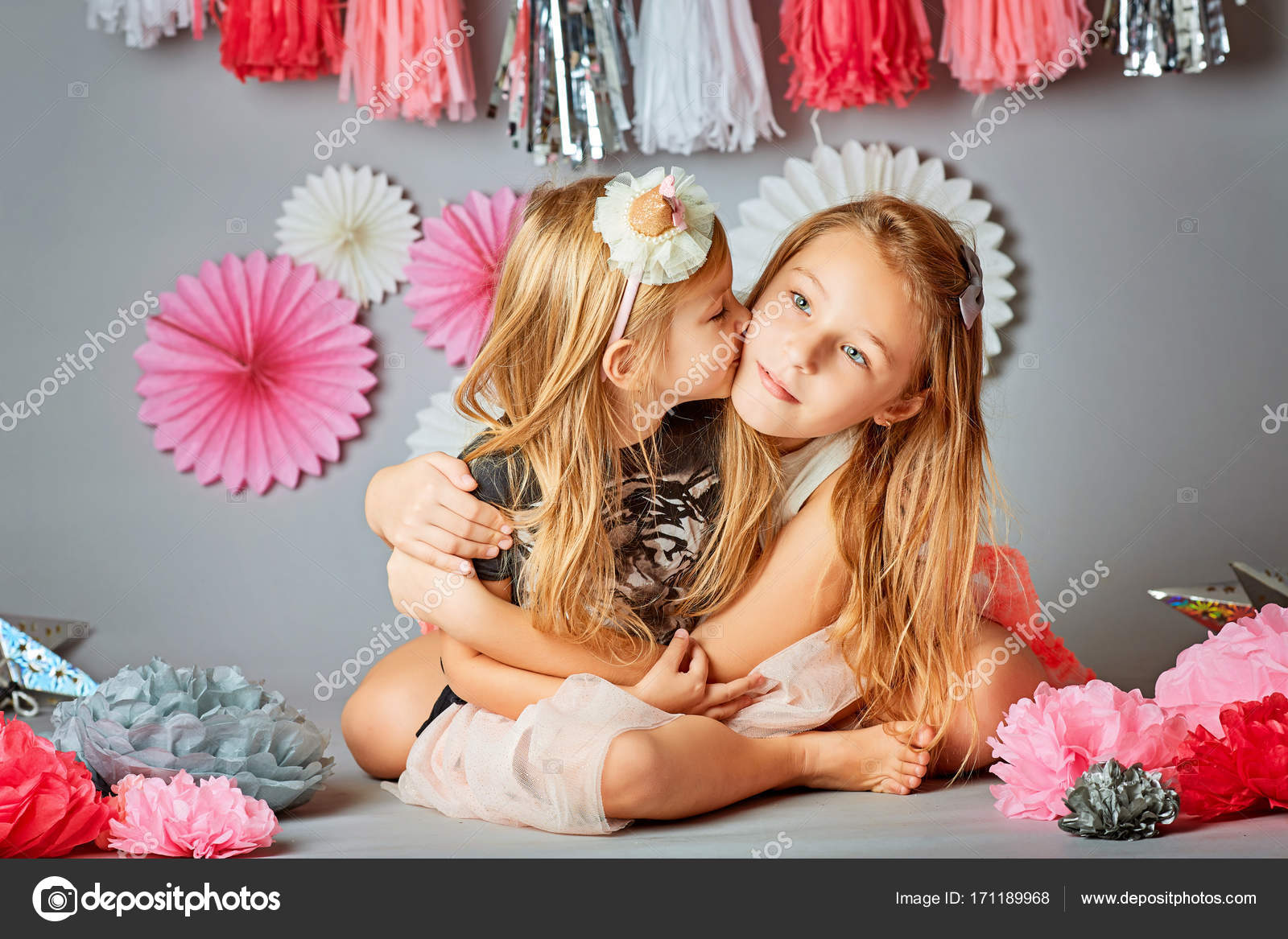 Two cute young sisters posing together in a studio — Stock Photo ...