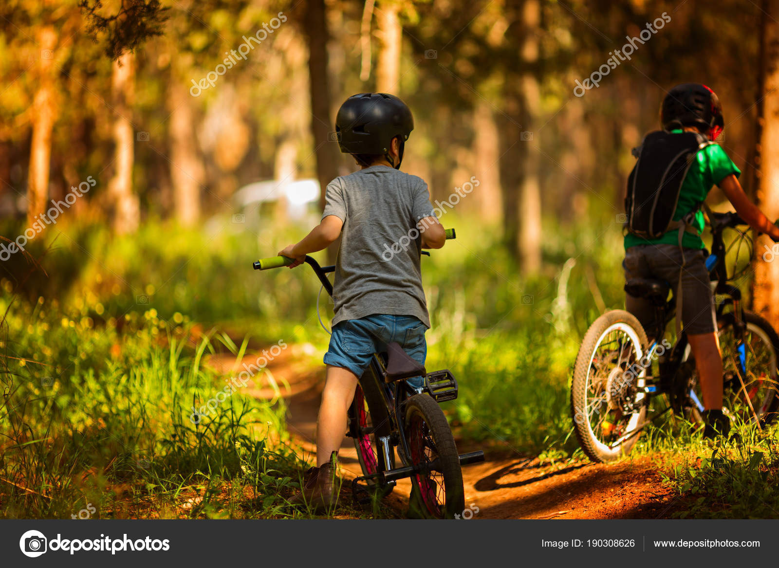 Little kids riding their bikes in park Stock Photo by ©pavlovski.info ...