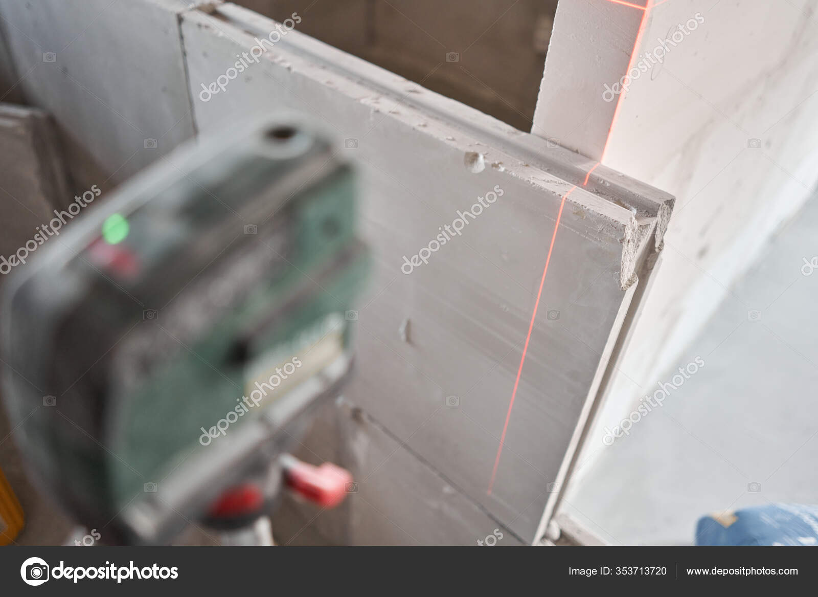 The construction worker Measures horizon level with a laser level ...