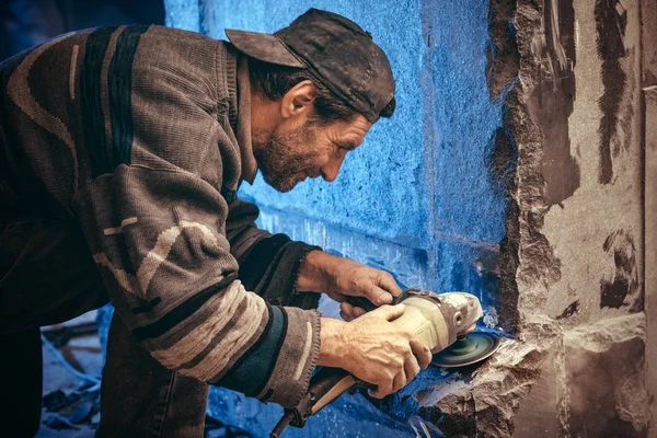 The worker processes the granite stone with a grinder. — Stock Photo ...