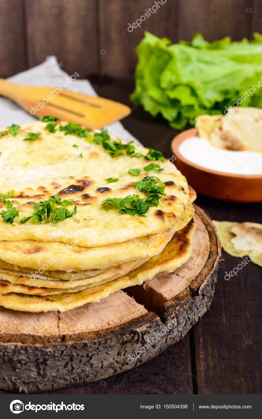 Thin flatbread - traditional Asian bread on a dark wooden background ...
