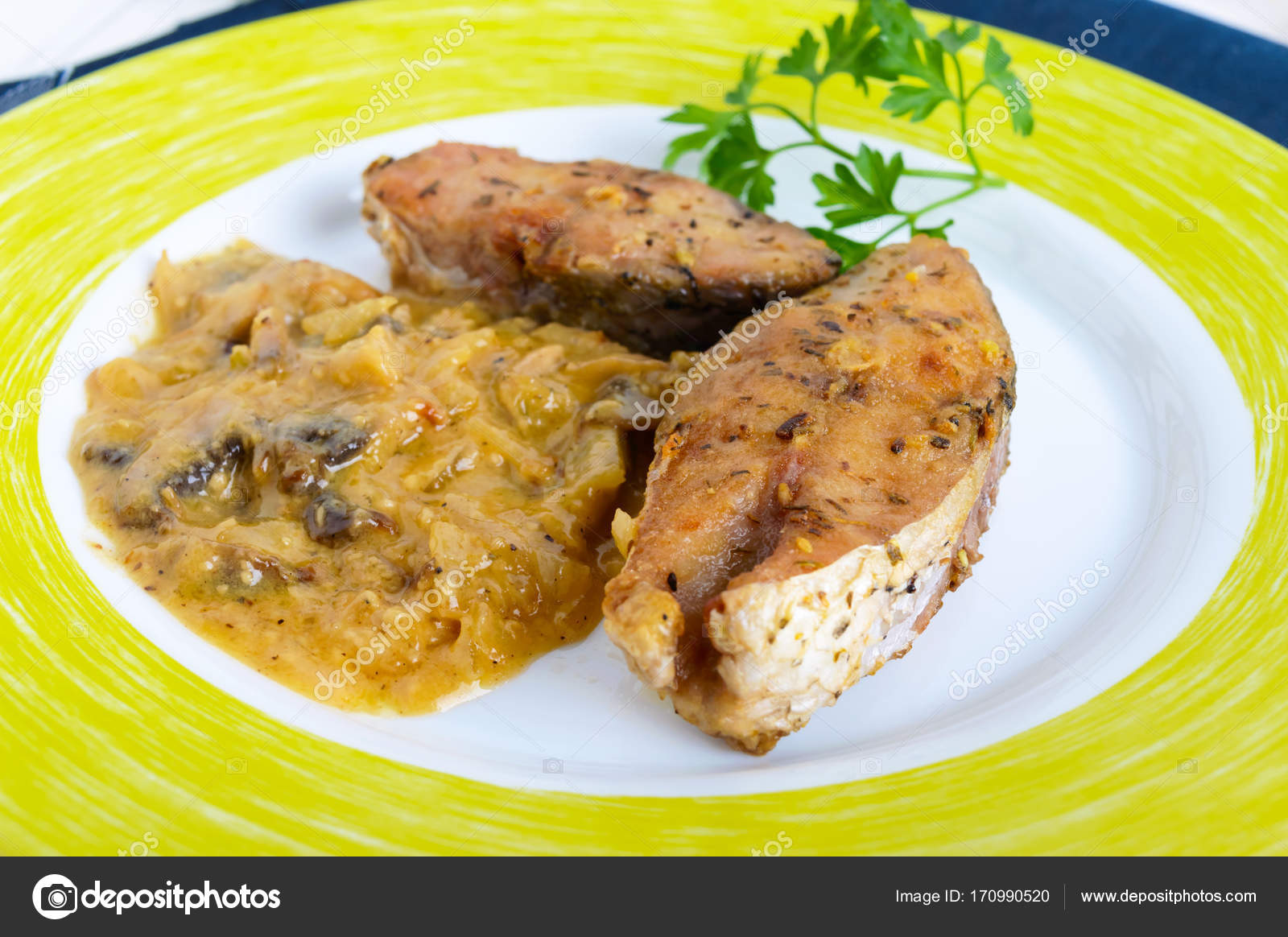 Roasted carp steaks with mushroom sauce on a plate Stock Photo by ...
