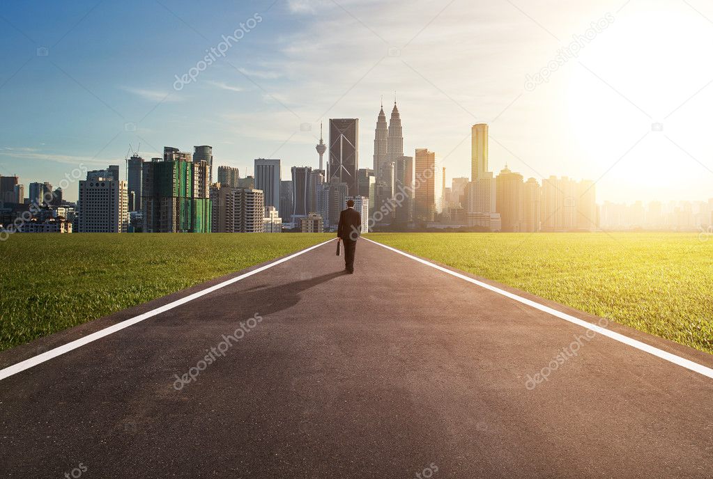 Man walking on the road towards city Stock Photo by ©jamesteohart 126069052