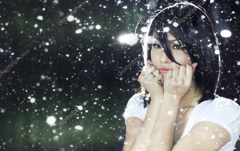 Asian girl under snowfall — Stock Photo © jamesteohart #126071094