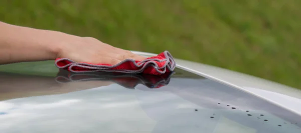close-up of a hand wiping a car glass with a red rag - Stock Image ...