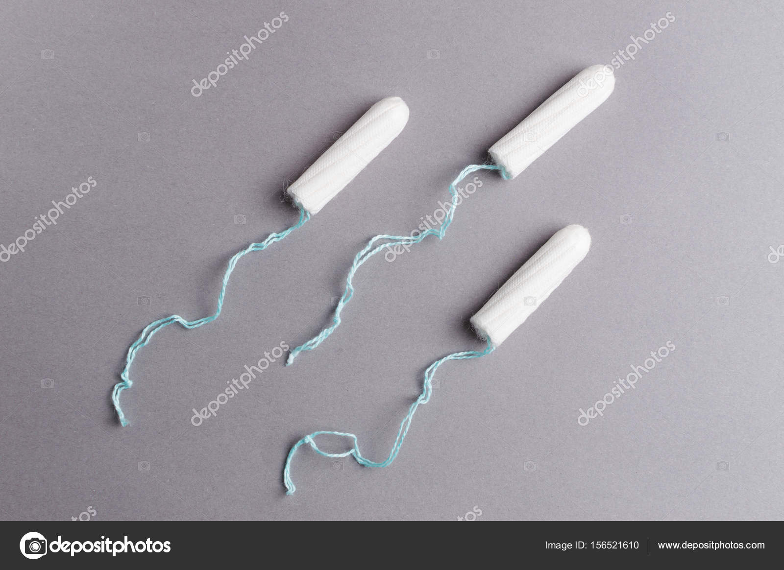 Menstrual tampon on a grey background. Menstruation time. Hygiene and ...