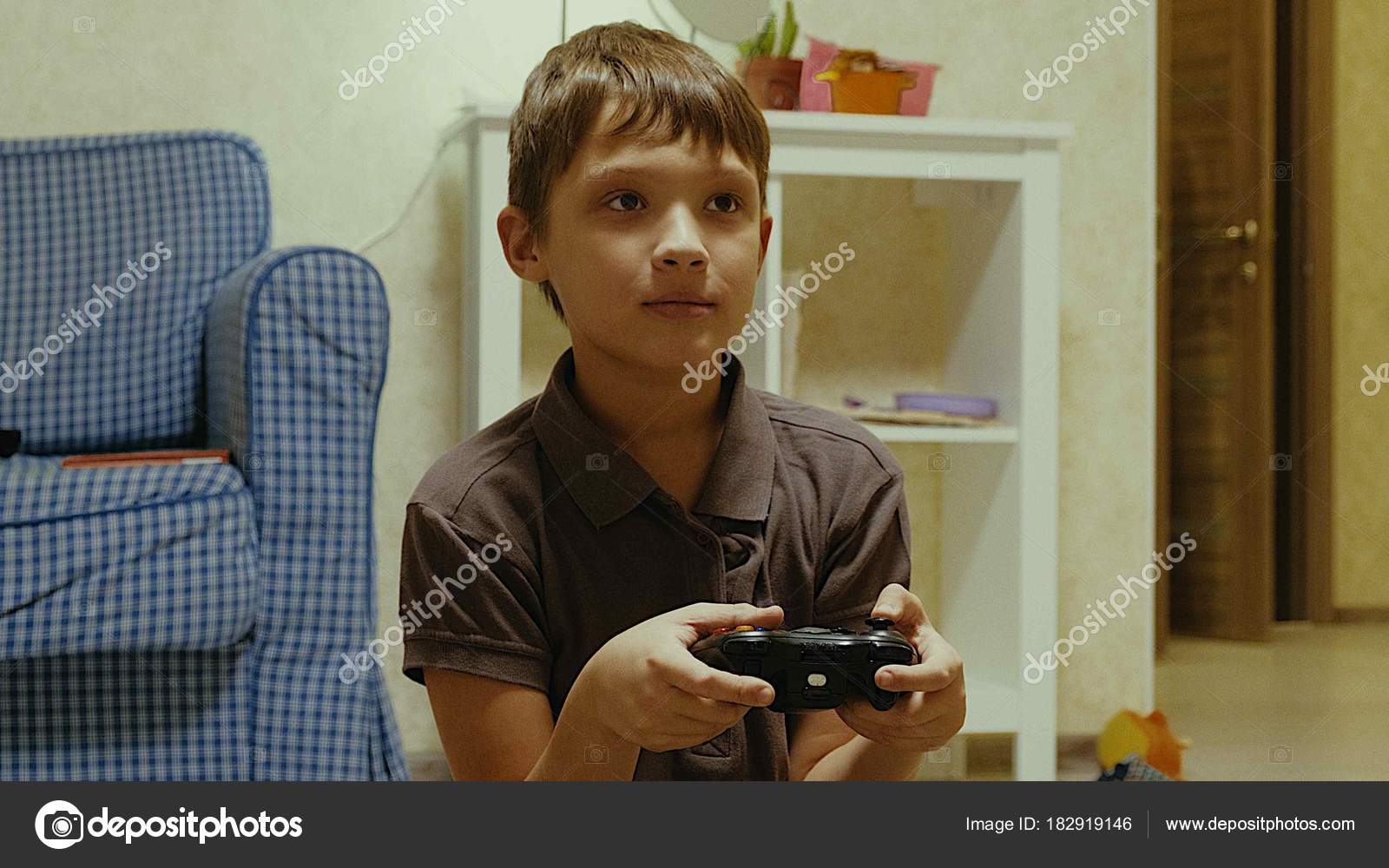 Boy using a controller to play a video-game — Stock Photo © purtoff ...