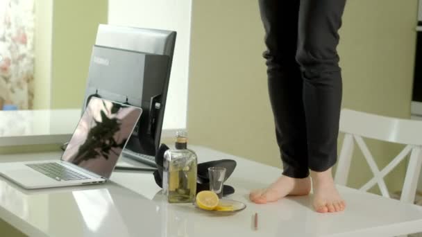A drunk business woman dances on a table, on a table computers and a ...