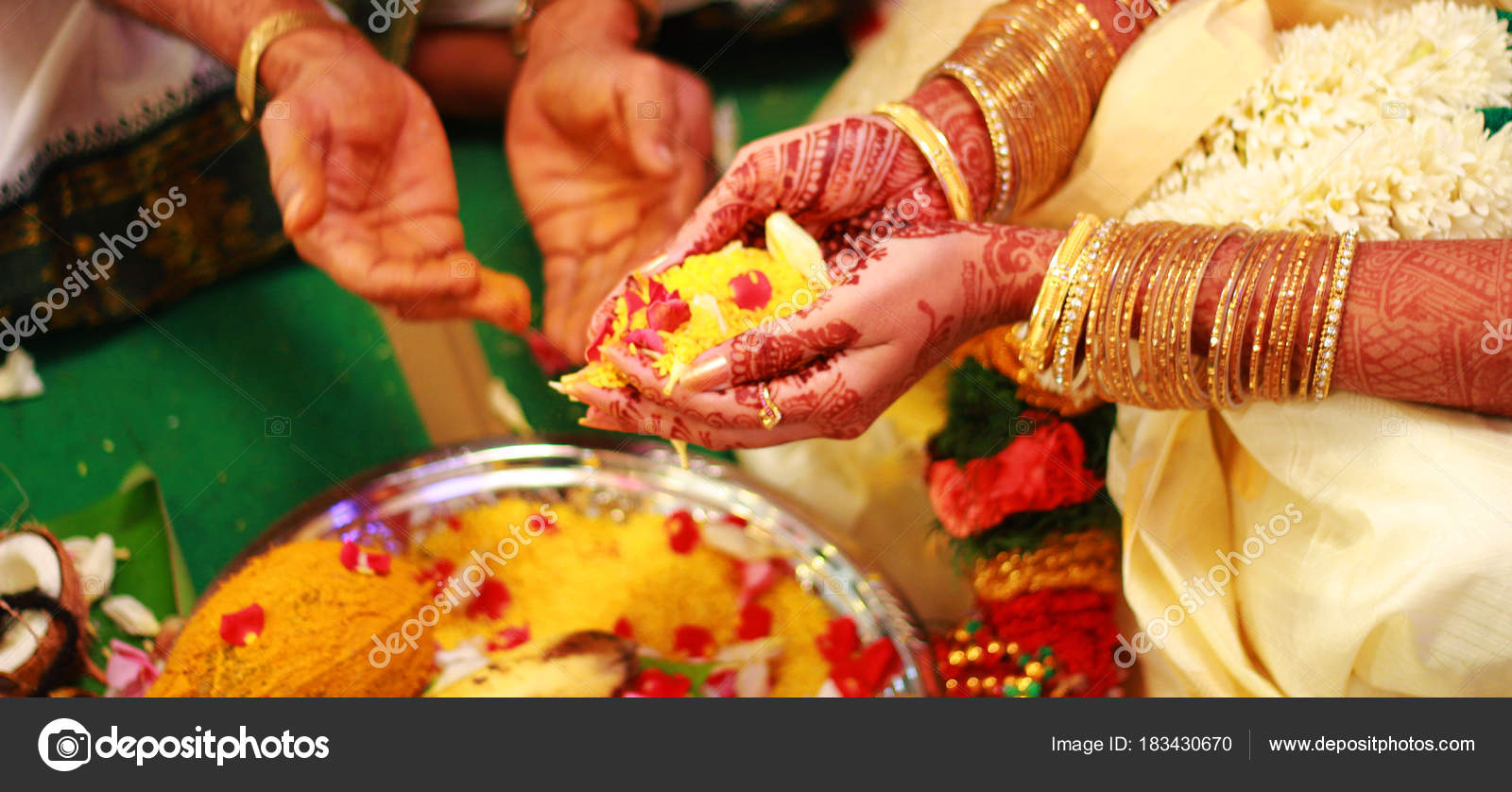 The hand of the bride held by a groom during a traditional ritual in an ...