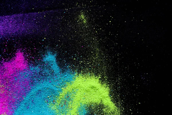 Multi-colored powder sprayed on black background. Holi celebration ...