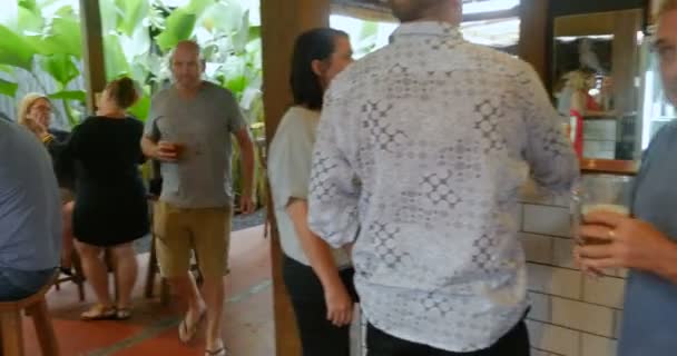 POV - walking through a bar with people drinking beer and smoking ...