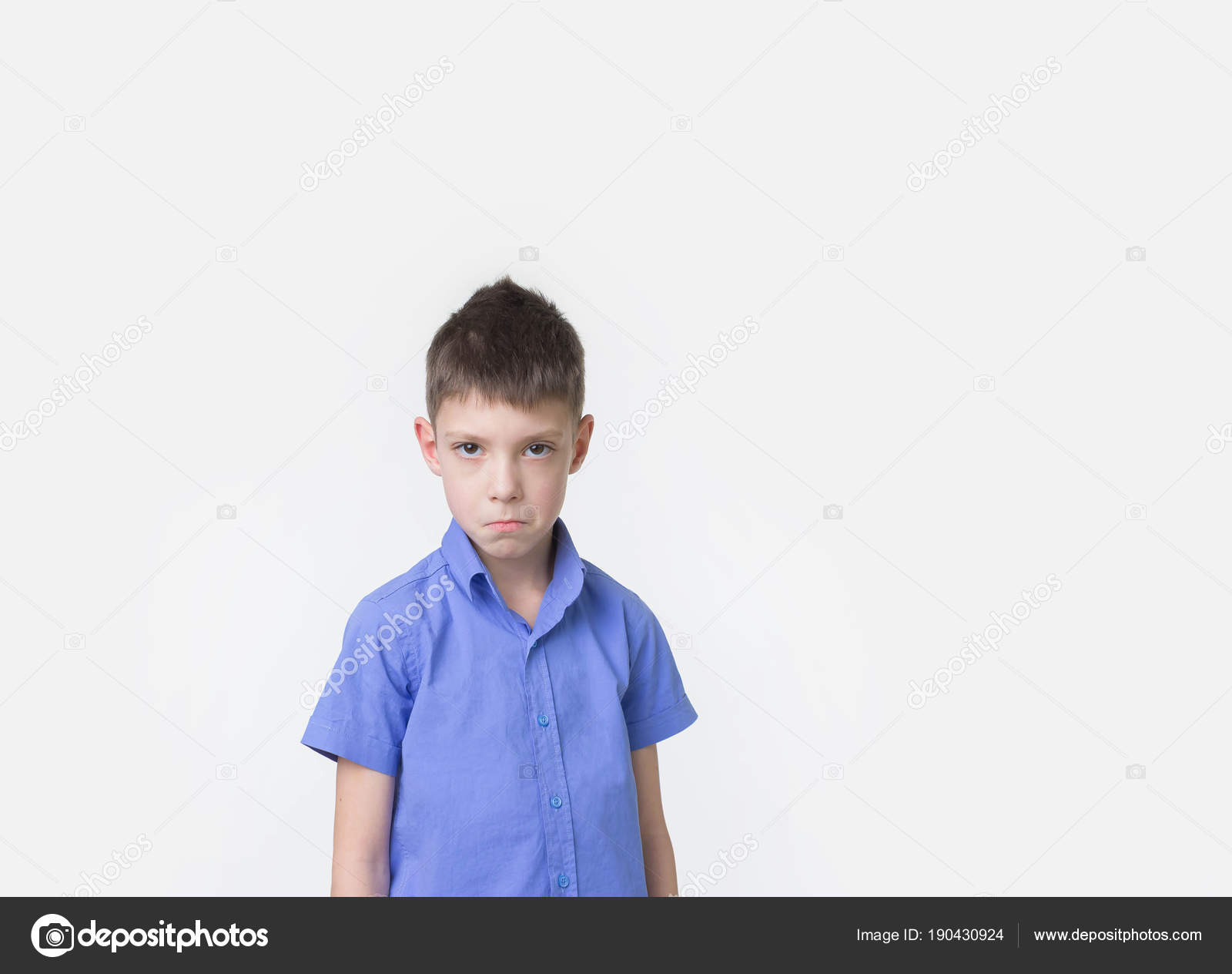 Handsome eight year old boy posing in studio over white background ...