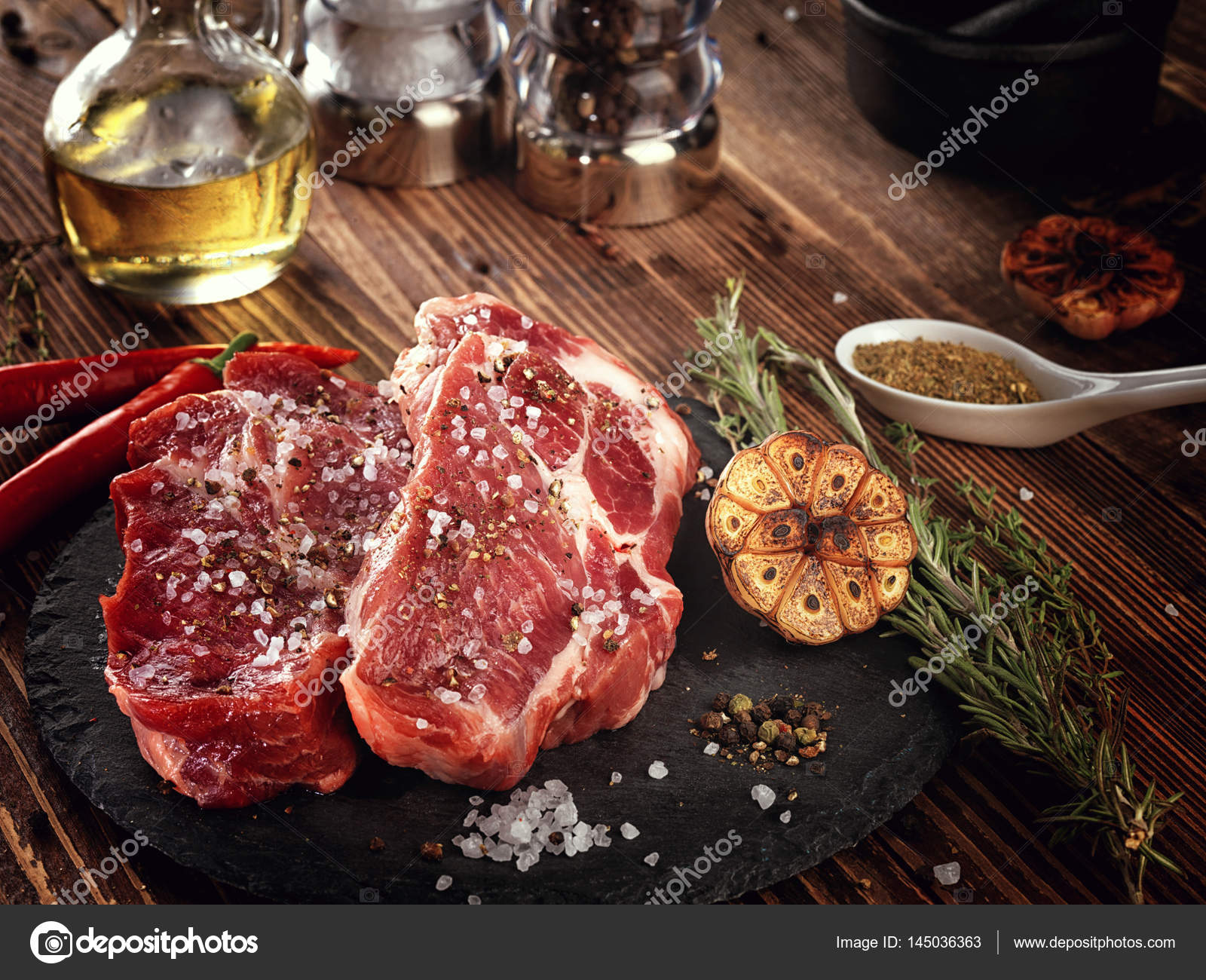 Raw pork neck steak on a stone plate. — Stock Photo © Onradi #145036363