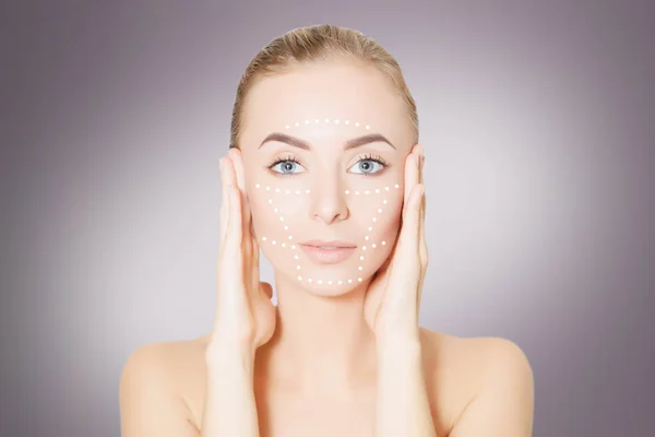 young Woman face with marks and arrows on grey - Stock Image - Everypixel