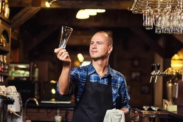 Barman at work in pub,Portrait of cheerful barman worker standing ...