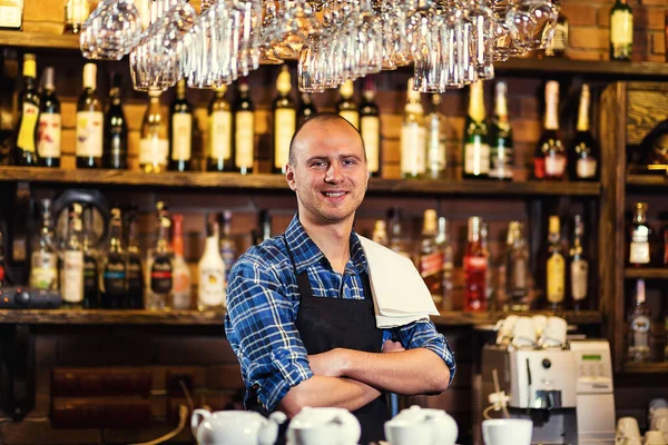 Barman at work in pub,Portrait of cheerful barman worker standing ...