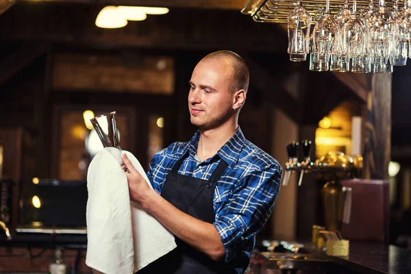 Barman at work in pub,Portrait of cheerful barman worker standing ...