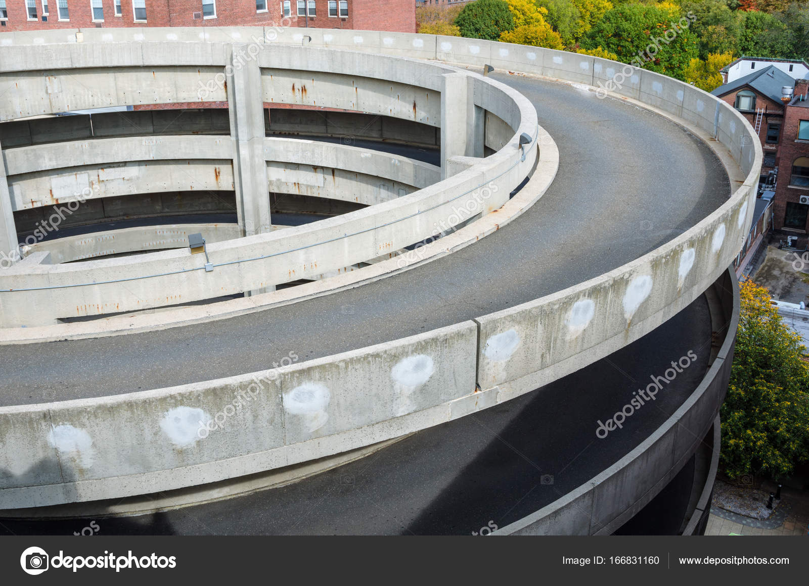Exterior Parking Garage Ramp Car Driving Down A Spiral Ramp In A