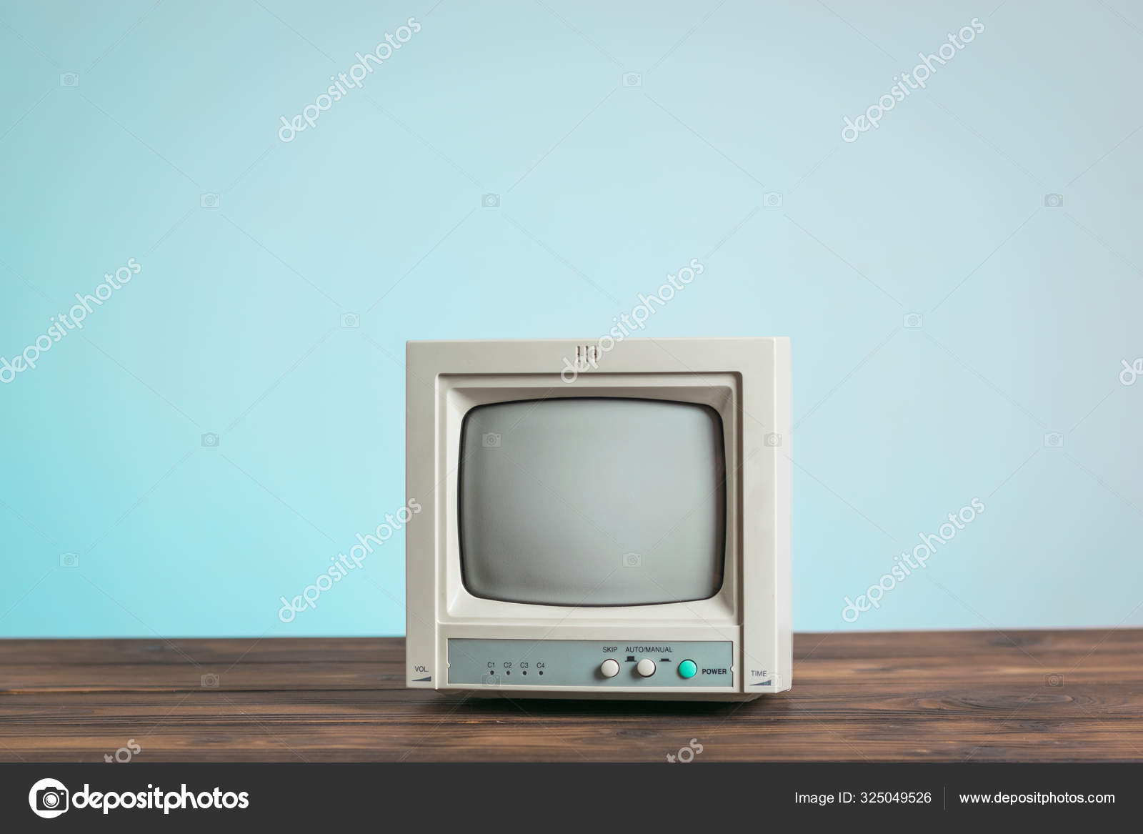 The old monitor on a wooden table on a blue background. Stock Photo by ...