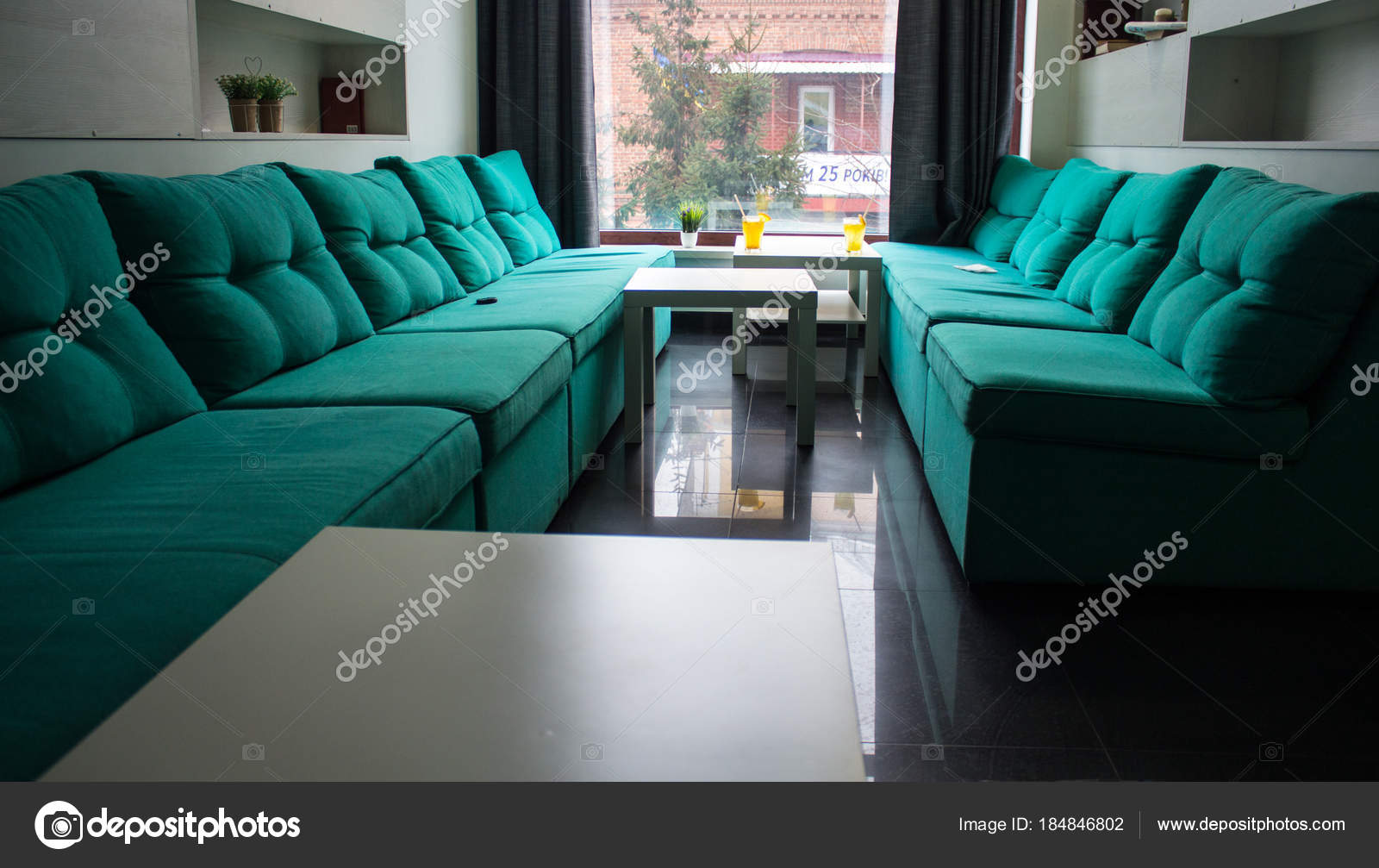 Sofa and table on window background — Stock Photo © iLiApodo1988 #184846802