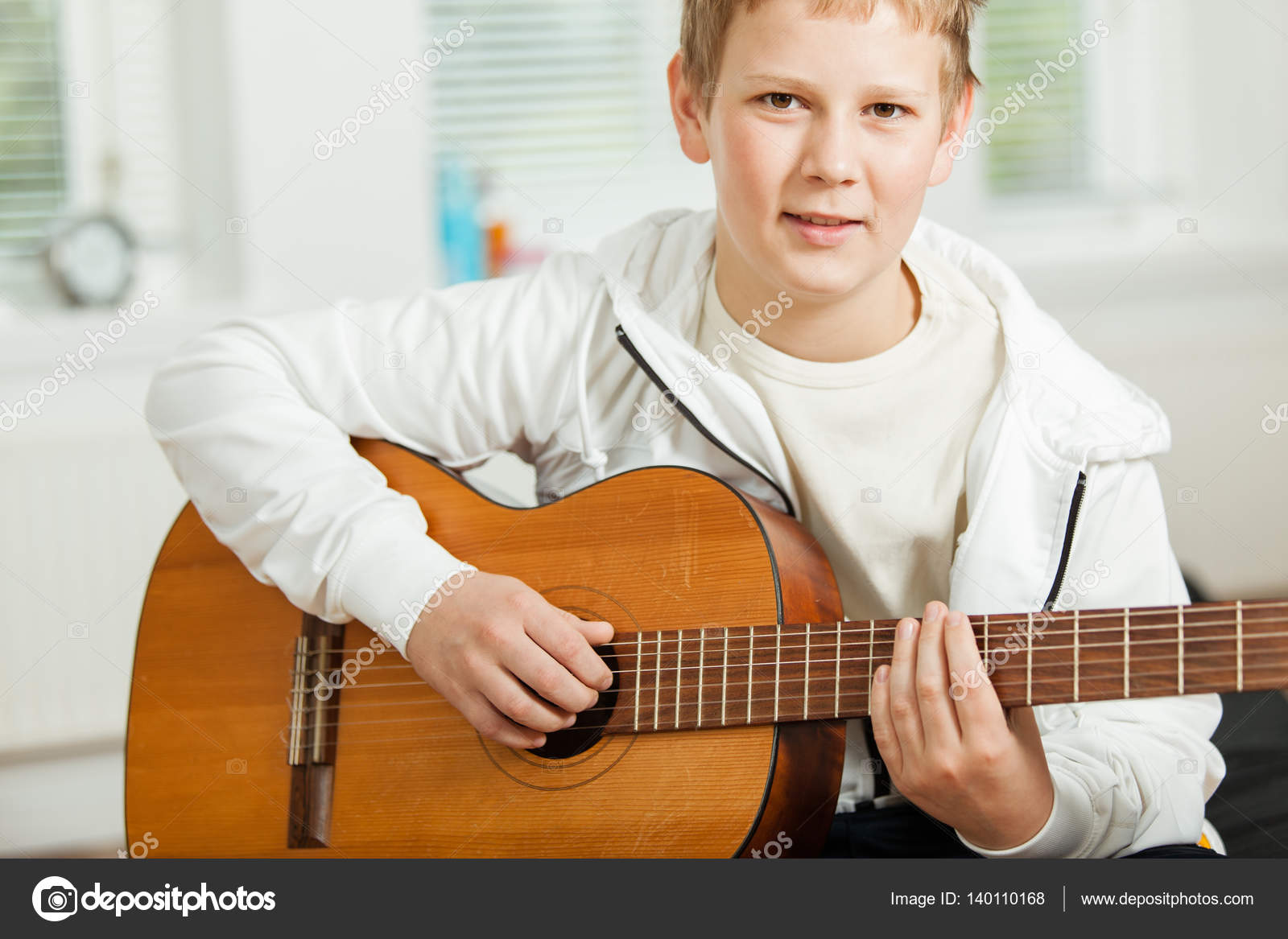 Teenage boy playing guitar Stock Photo by ©jhandersen 140110168