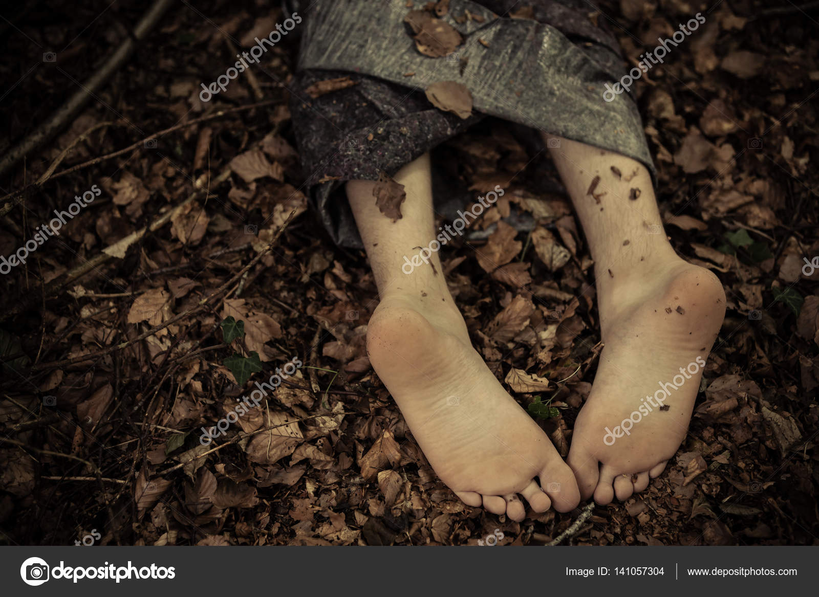 Dead body feet in leaves Stock Photo by ©jhandersen 141057304