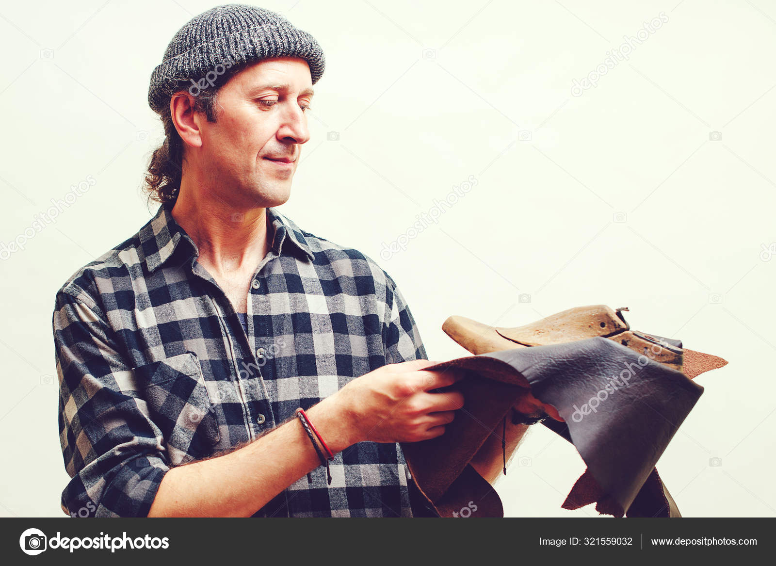 Fashion designer modeling new shoe at his workshop. Small business ...