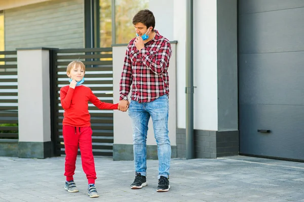 Family in face masks going for walk. Coronavirus prevention. Quarantine ...
