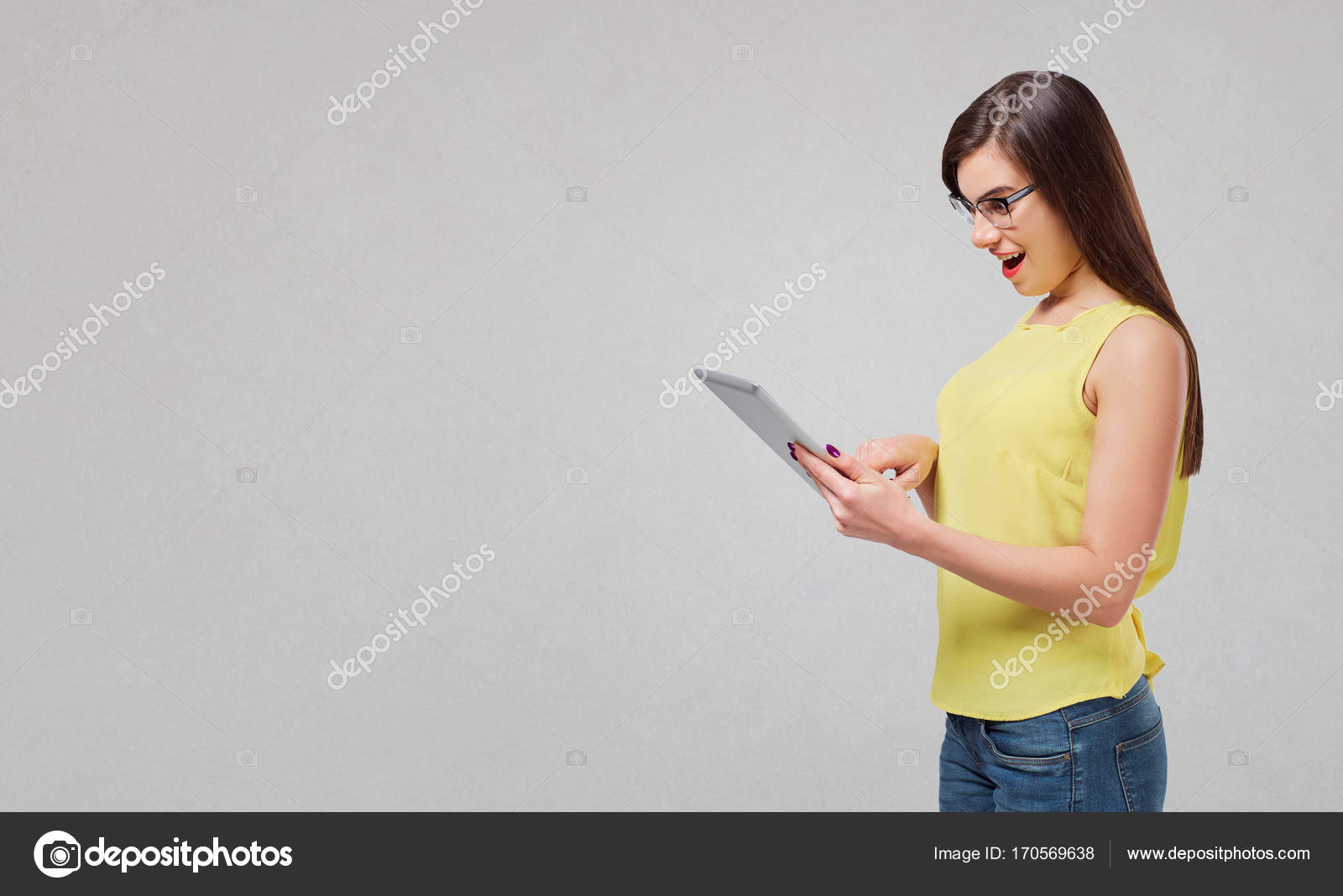 A girl uses a tablet with a smile. ⬇ Stock Photo, Image by © lacheev ...